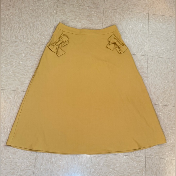 Collectif | Skirts | Collectif Mustard Aline Skirt With Bow Accents ...